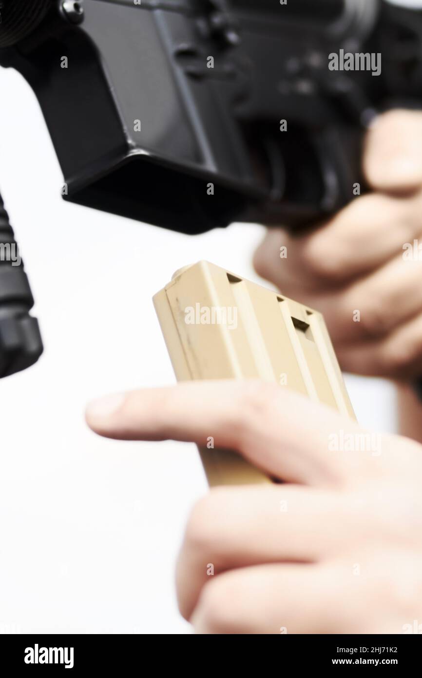 Rifle reload. Closeup on a soldier's hand reloading ammunition into a ...