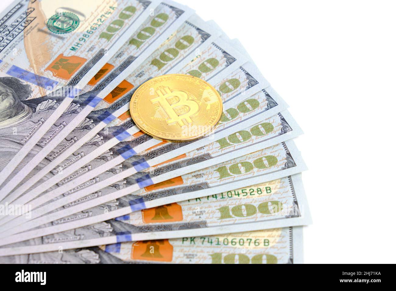 An unfolded bundle hundred dollar bills and one bitcoin coin on white ...