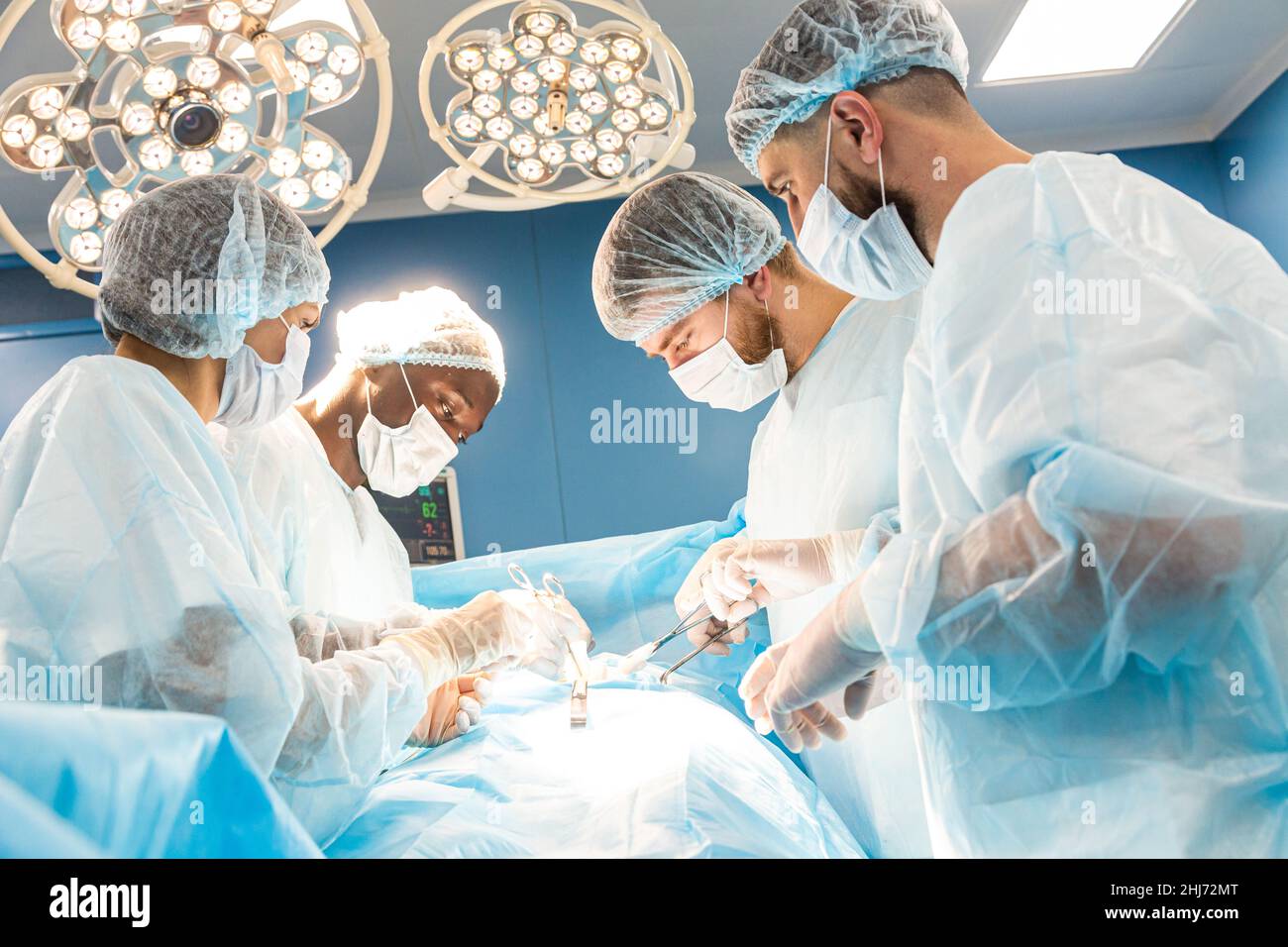 An international team of doctors performs a complex surgical operation ...