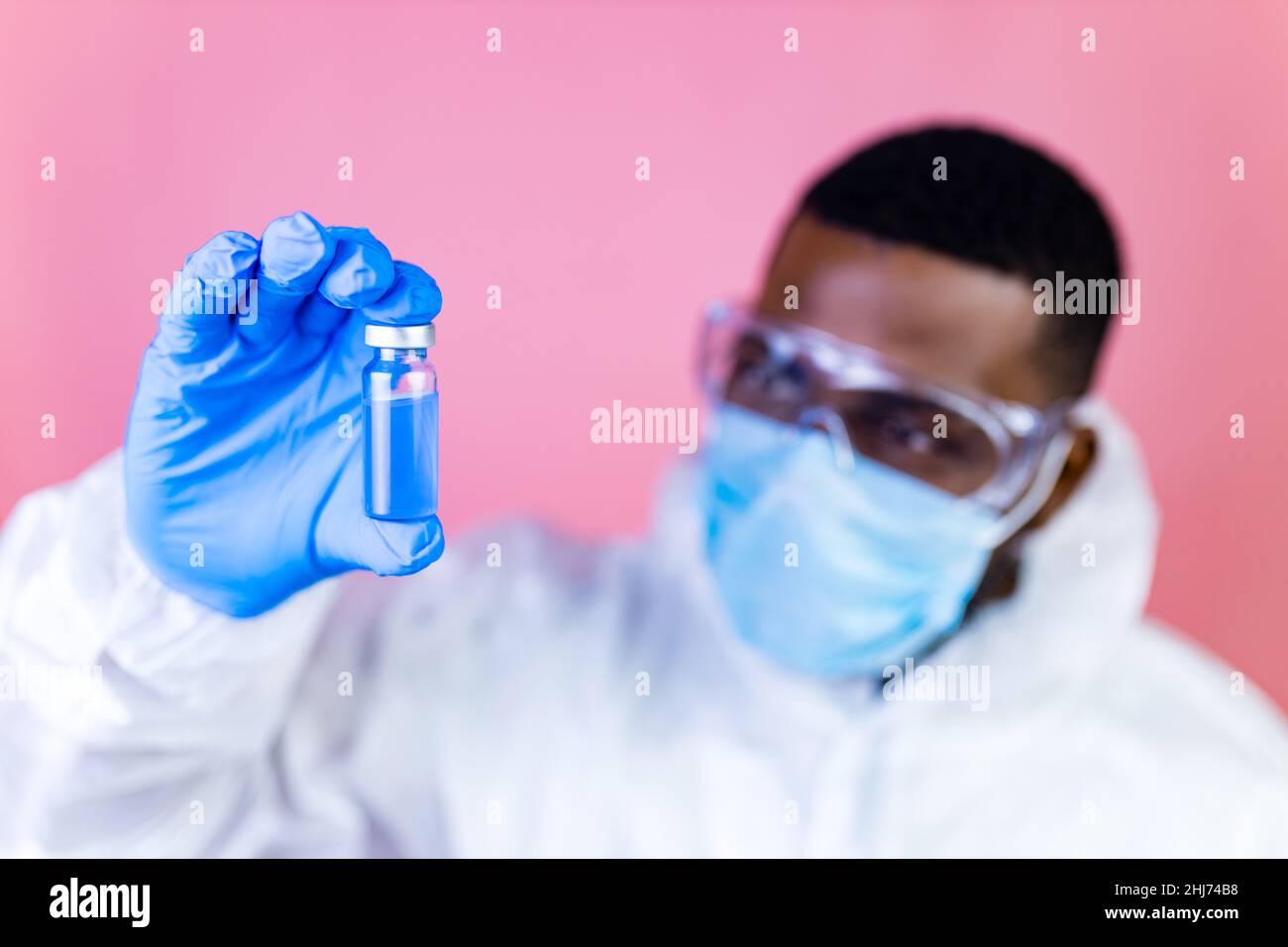Corona Virus SARS-CoV-2 vaccination concept : man in pink studio wall ...