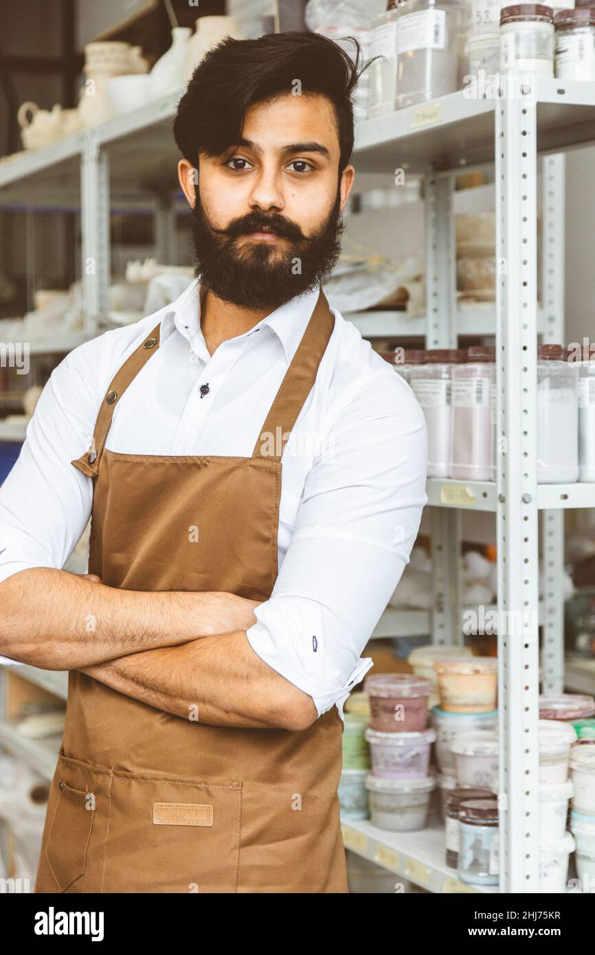 Portrait of a young attractive businessman craftsman with a beard and ...