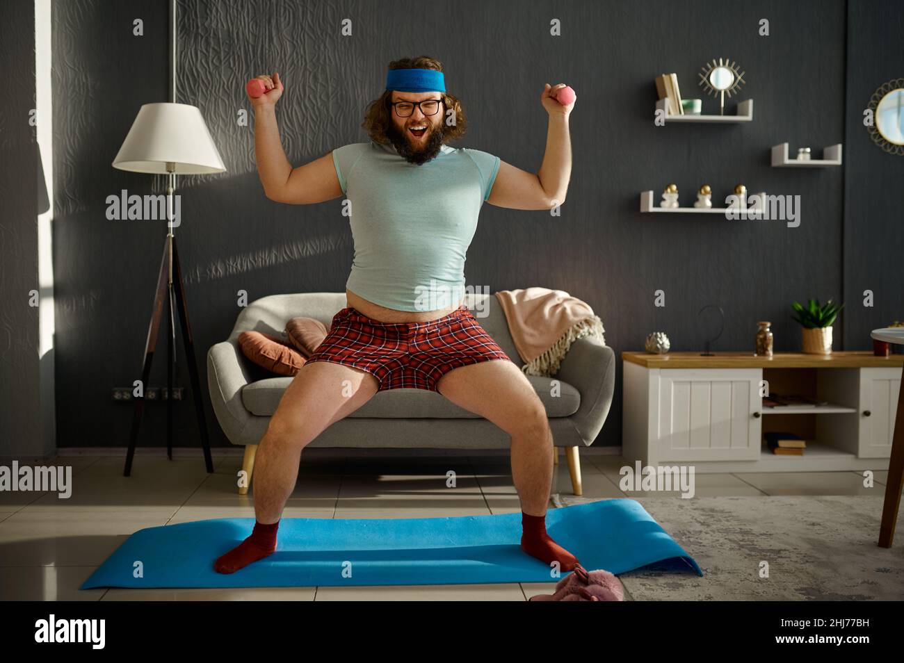 Funny oversize man showing strong muscles power Stock Photo - Alamy