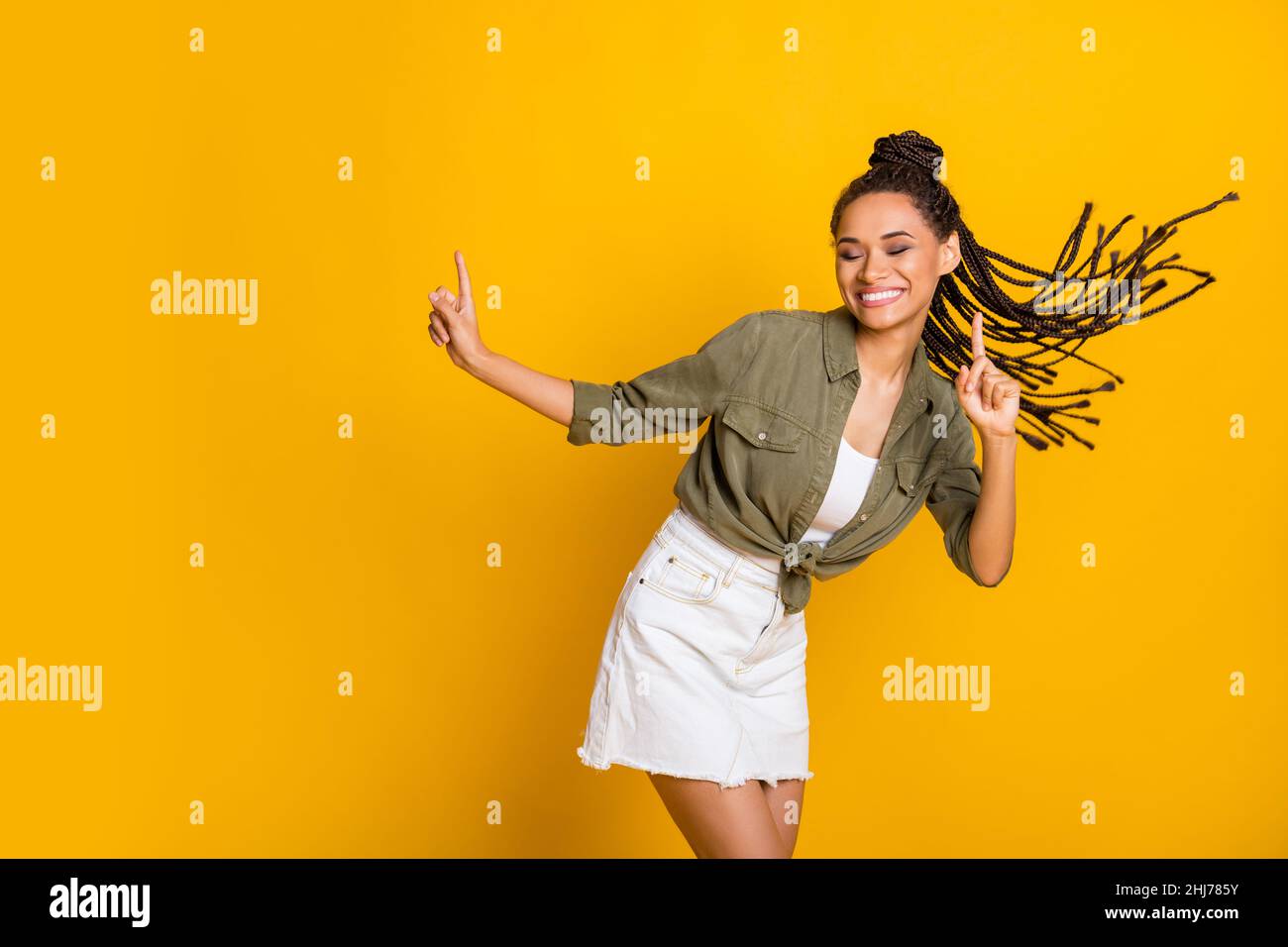 Photo portrait of dancing girl with closed eyes pointing fingers up ...