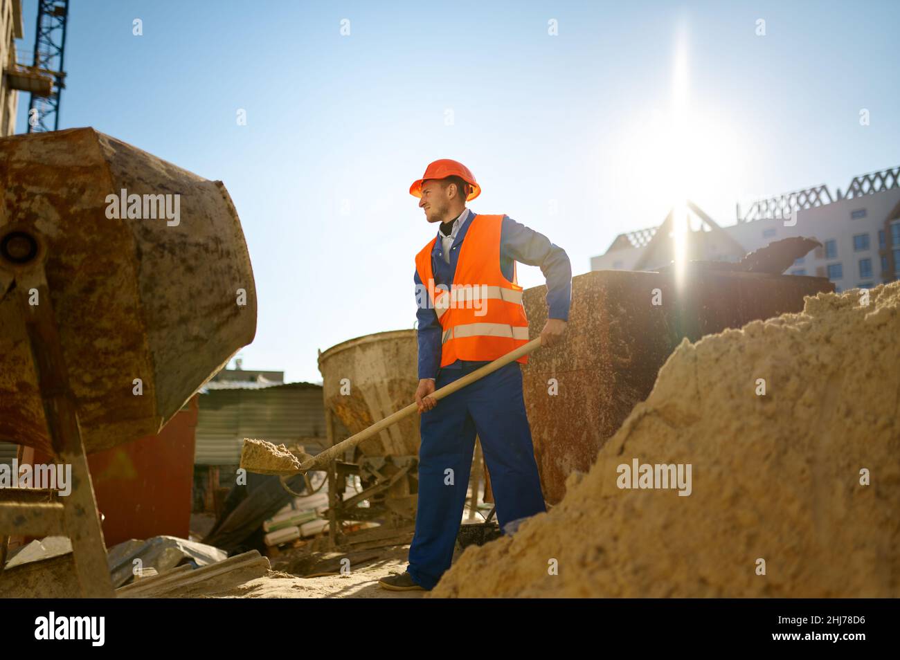 Male worker making concrete at construction site Stock Photo - Alamy