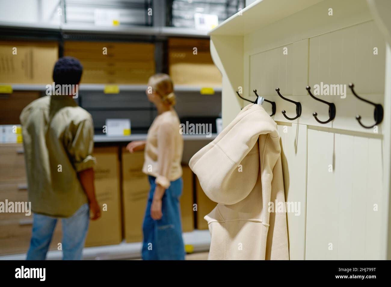 Furniture store showcase with couple on background Stock Photo - Alamy