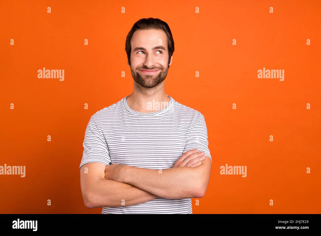 Photo of young man crossed hands wondered plan thoughtful look empty ...