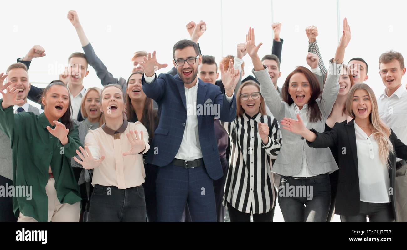 happy group of young employees with hands up Stock Photo - Alamy