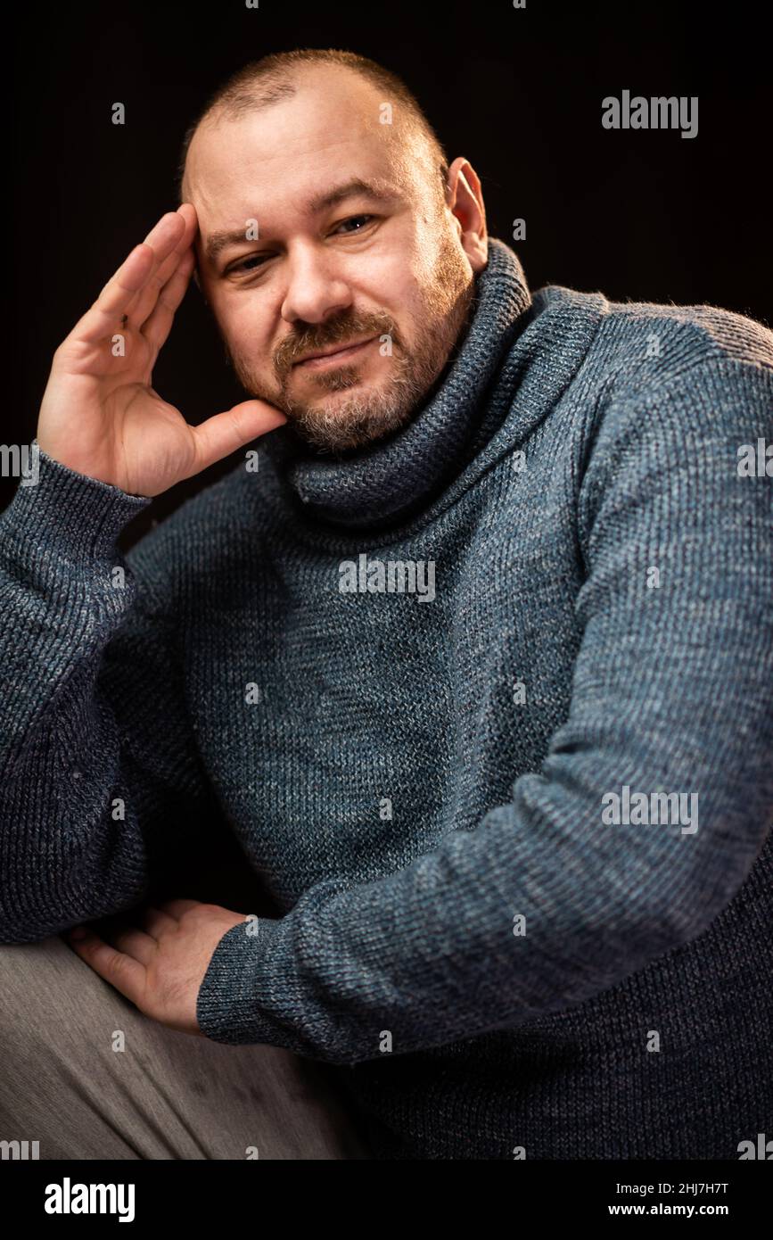 Middle-aged man in a sweater looking at the camera. Unshaven man of ...