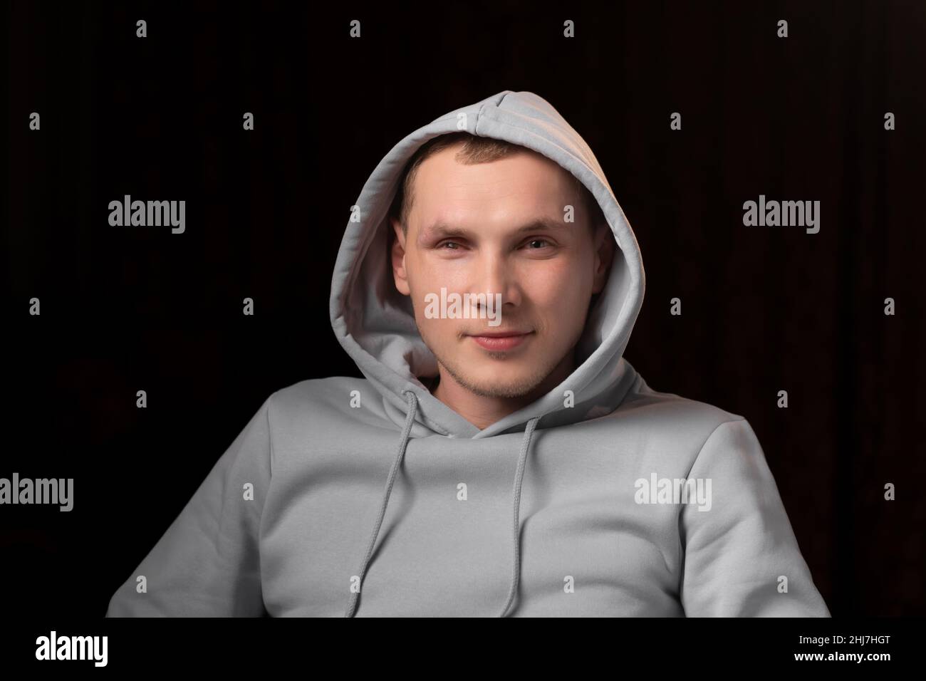 Portrait of a young man with a mutilated eye. Dark background. A young ...
