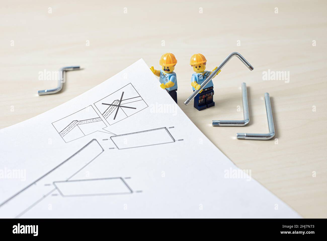Workers reading instruction to assemble furniture. DIY concept ...