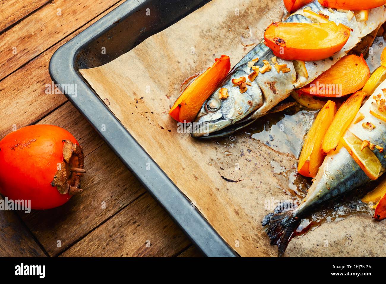 Fish food, baked mackerel. Fish in persimmon fruit Stock Photo - Alamy