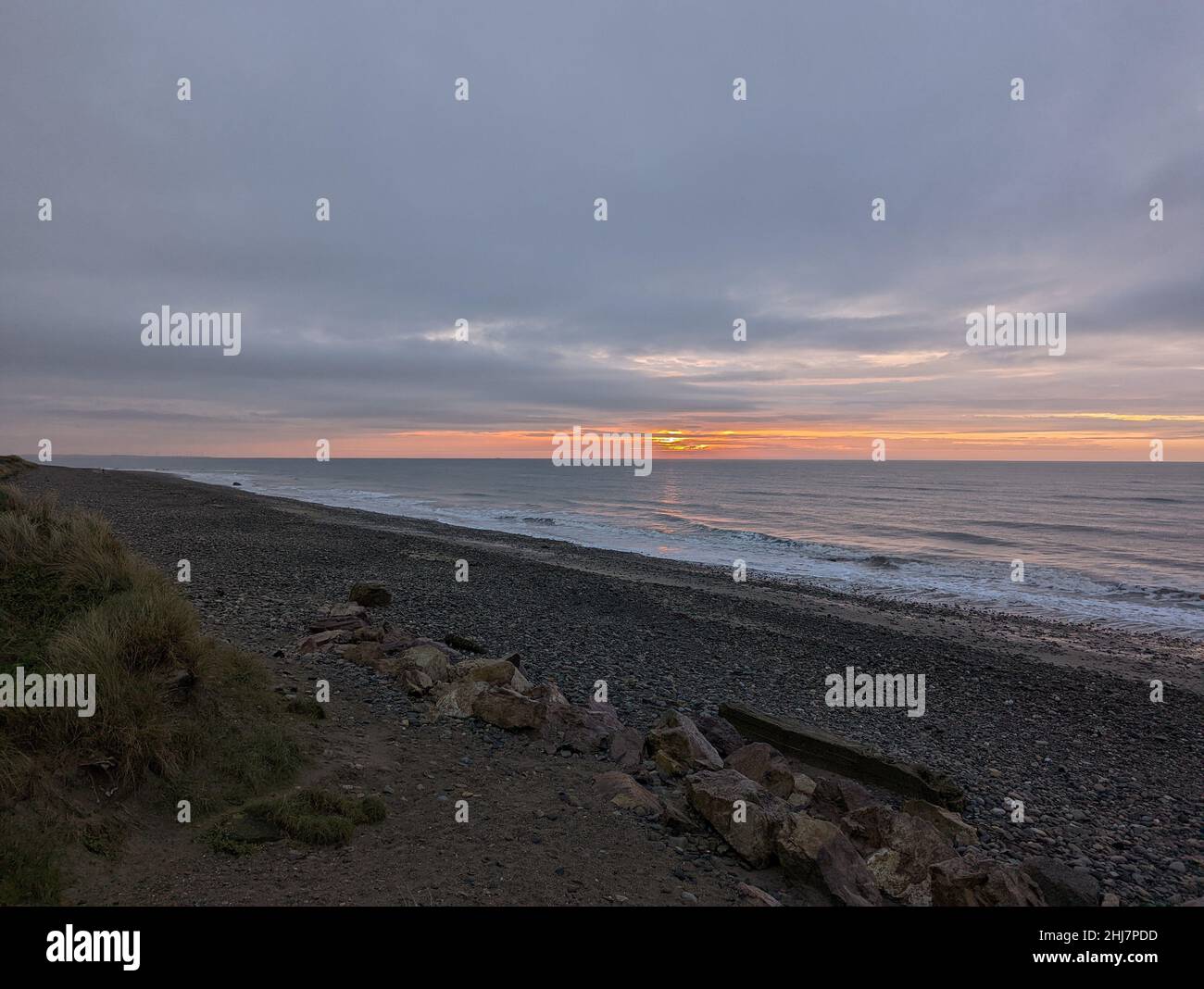 Beautiful view of sunset at a beach in Europe Stock Photo - Alamy