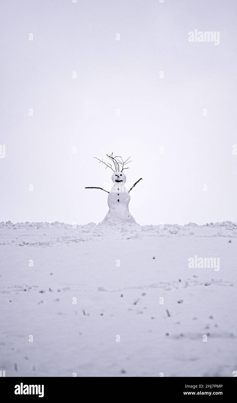 Vertical shot of a funny snowman on a snowy hill Stock Photo - Alamy