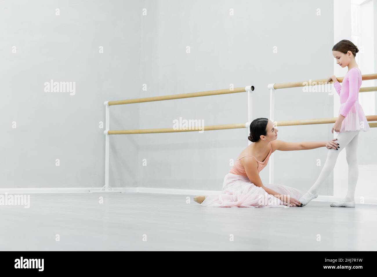 side view of ballet master teaching girl in dance school Stock Photo ...