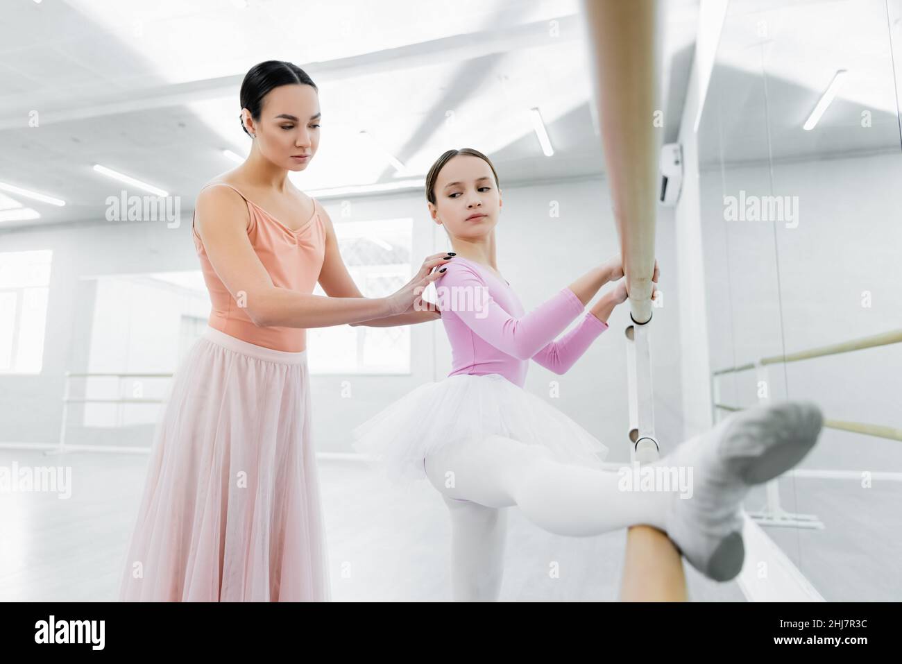 child stretching in ballet school near graceful dance teacher Stock ...