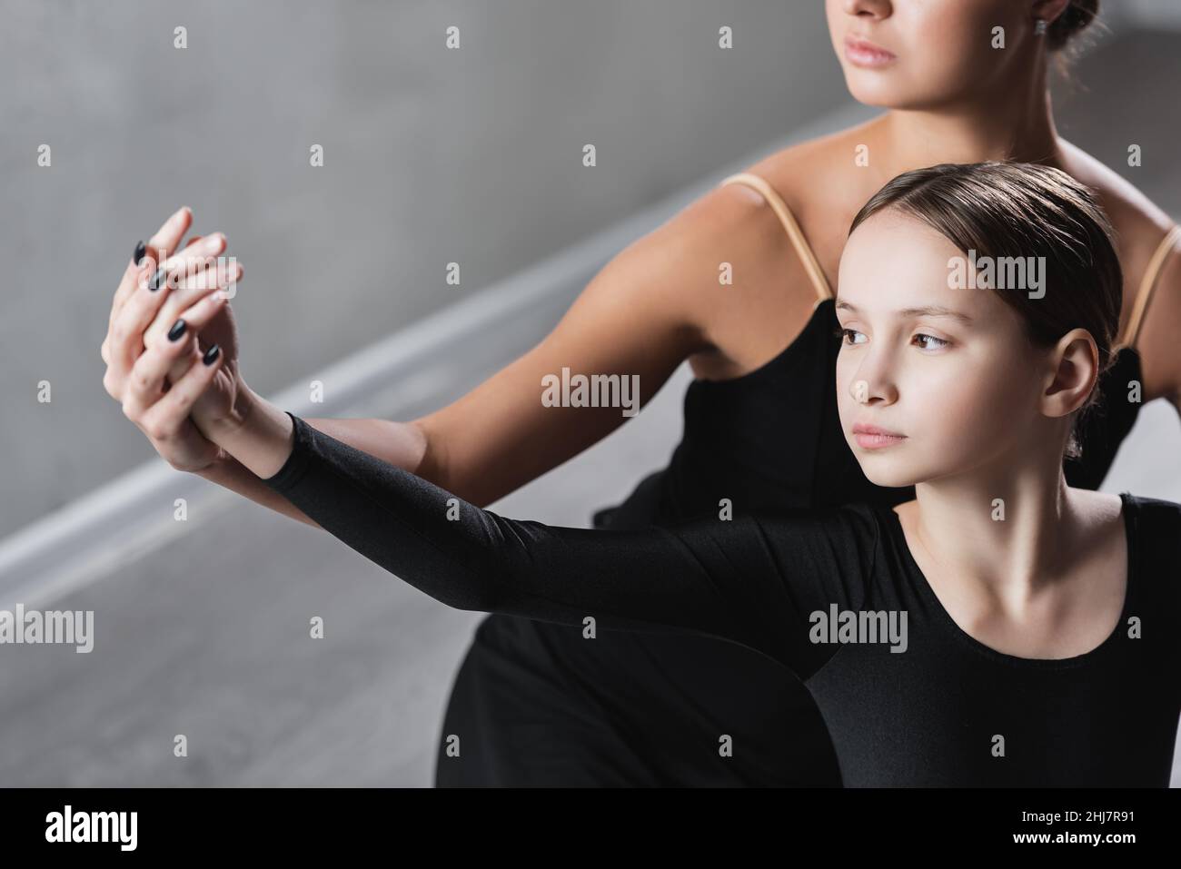 ballet teacher holding hand of girl during dance lesson Stock Photo - Alamy