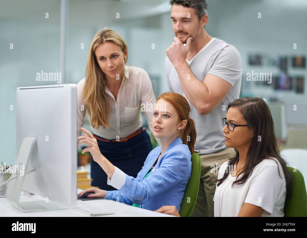 Wow look at all we've done. Shot of a group of colleagues looking at a ...