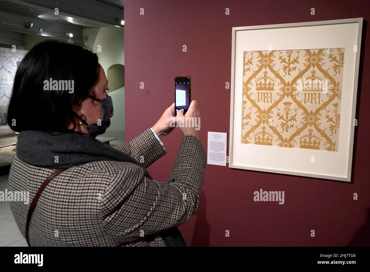 A person takes a picture of the print of The VRI Cipher Paper from 1887 ...