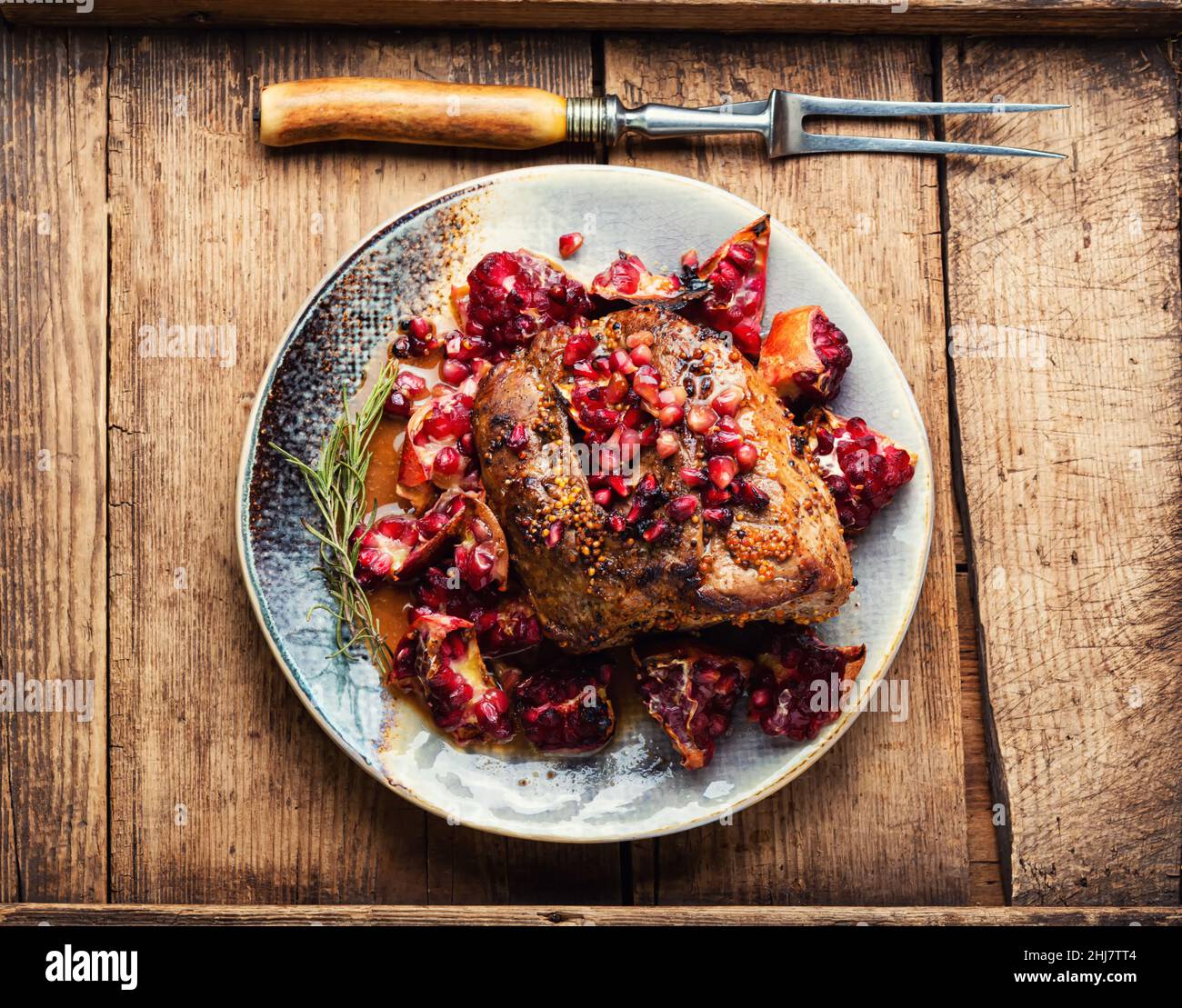 Delicious piece of meat fried with pomegranate Stock Photo - Alamy