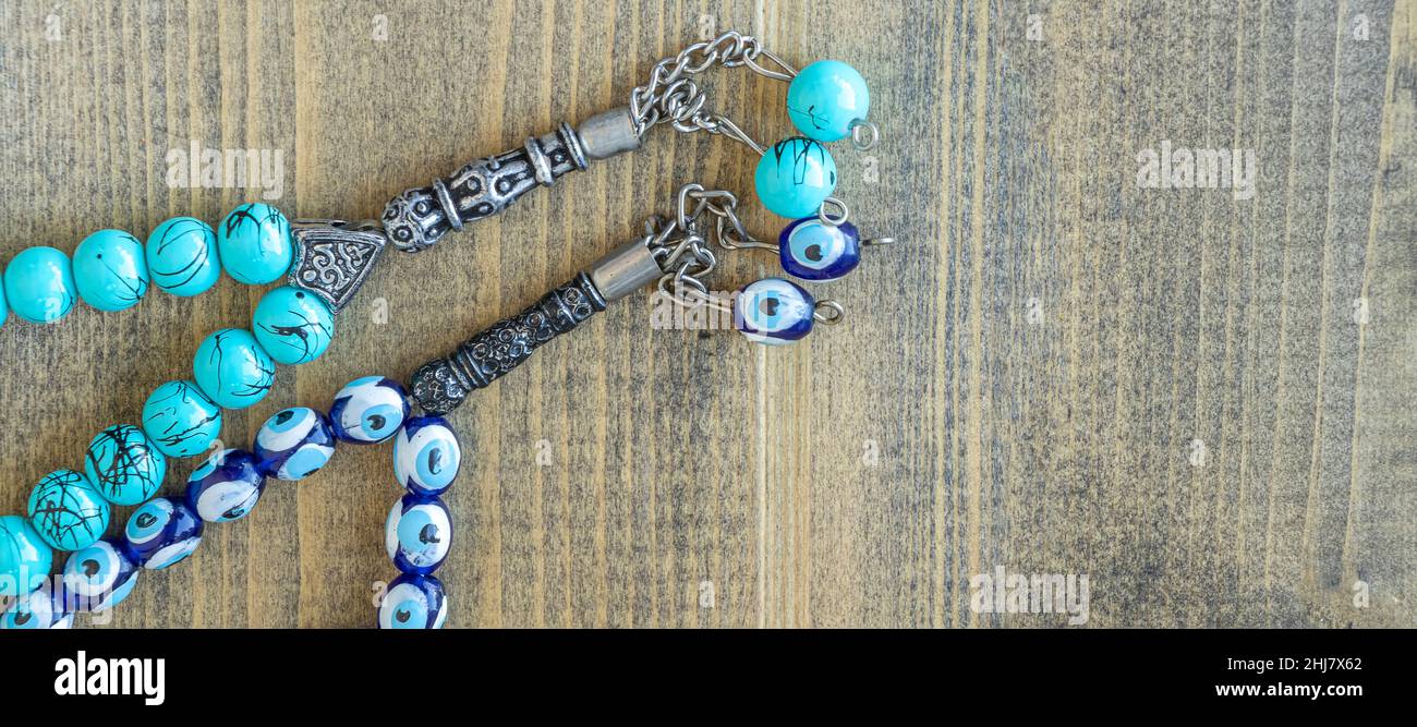 banner with two blue beads sequenced, short rosary on wooden table ...