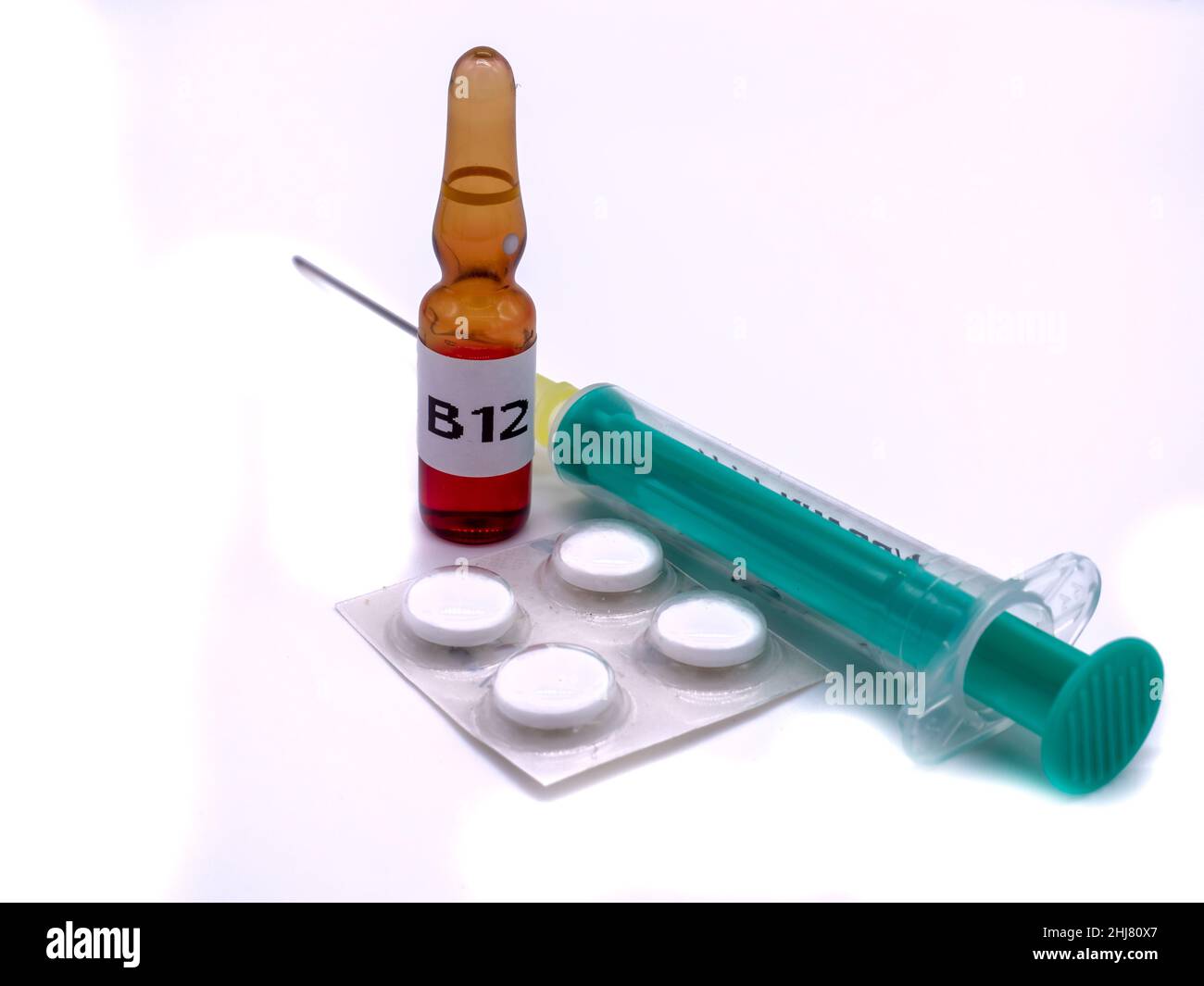 B12 ampule with syringe and tablets isolated on white background Stock ...