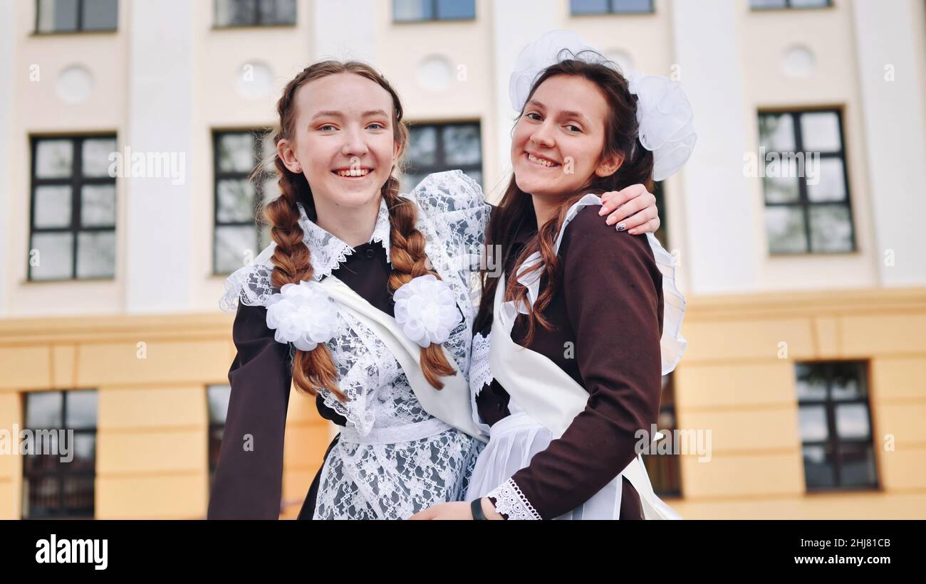 Happy Russian schoolgirls hug on their last school day Stock Photo - Alamy