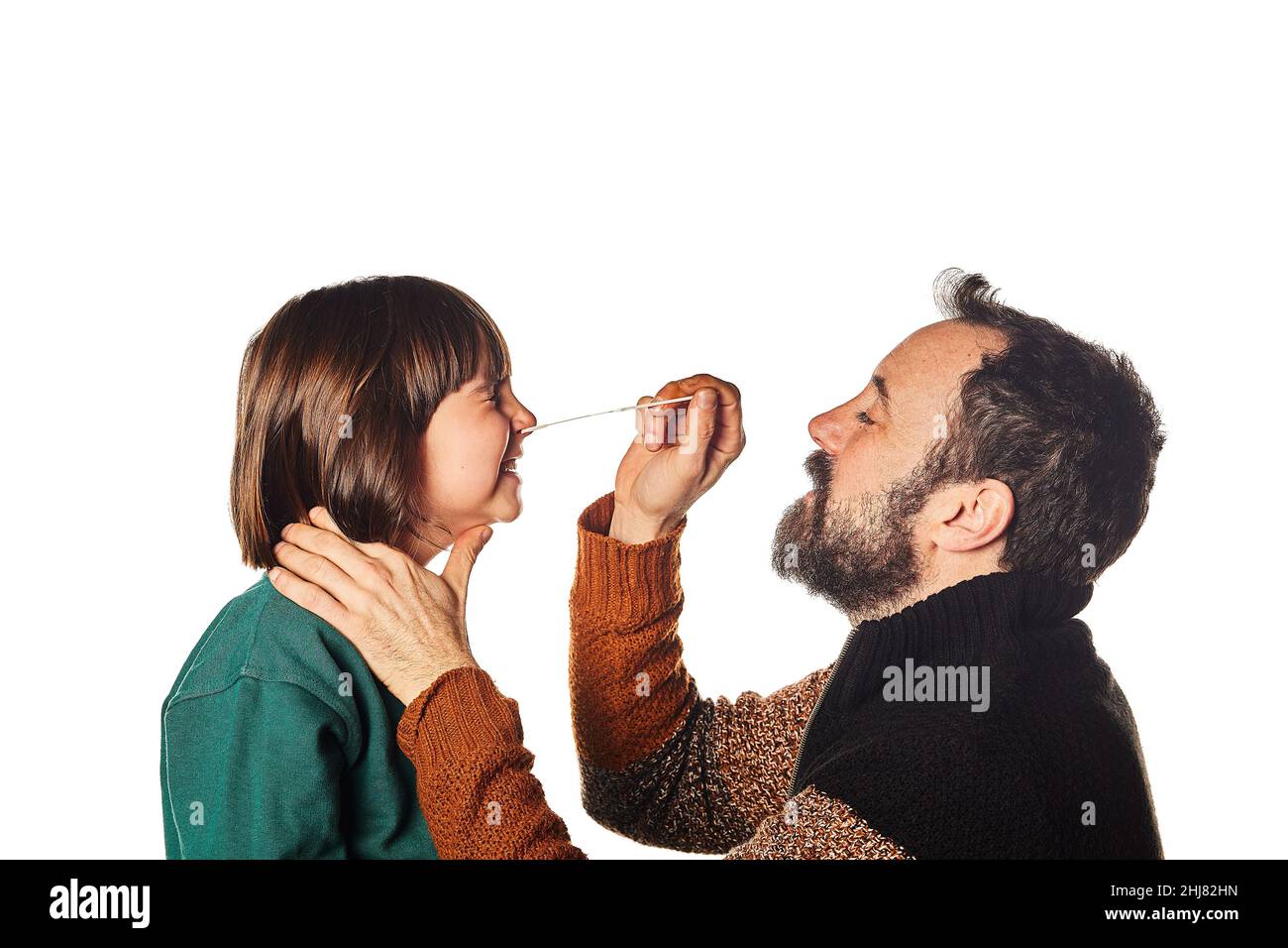 family taking a covid test on their daughter in school uniform and ...