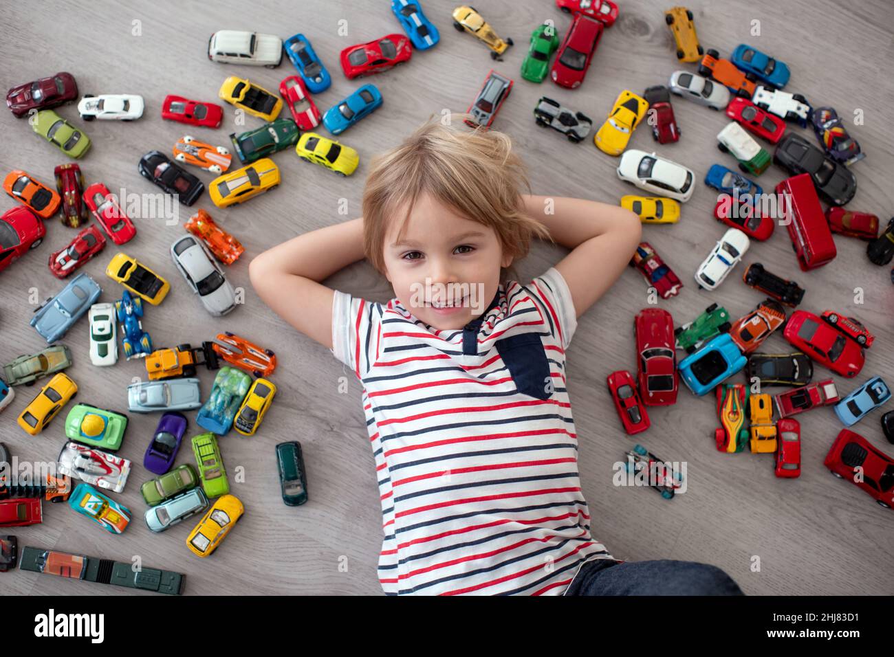 Cute toddler child, blond boy, playing with colofrul cars, different ...