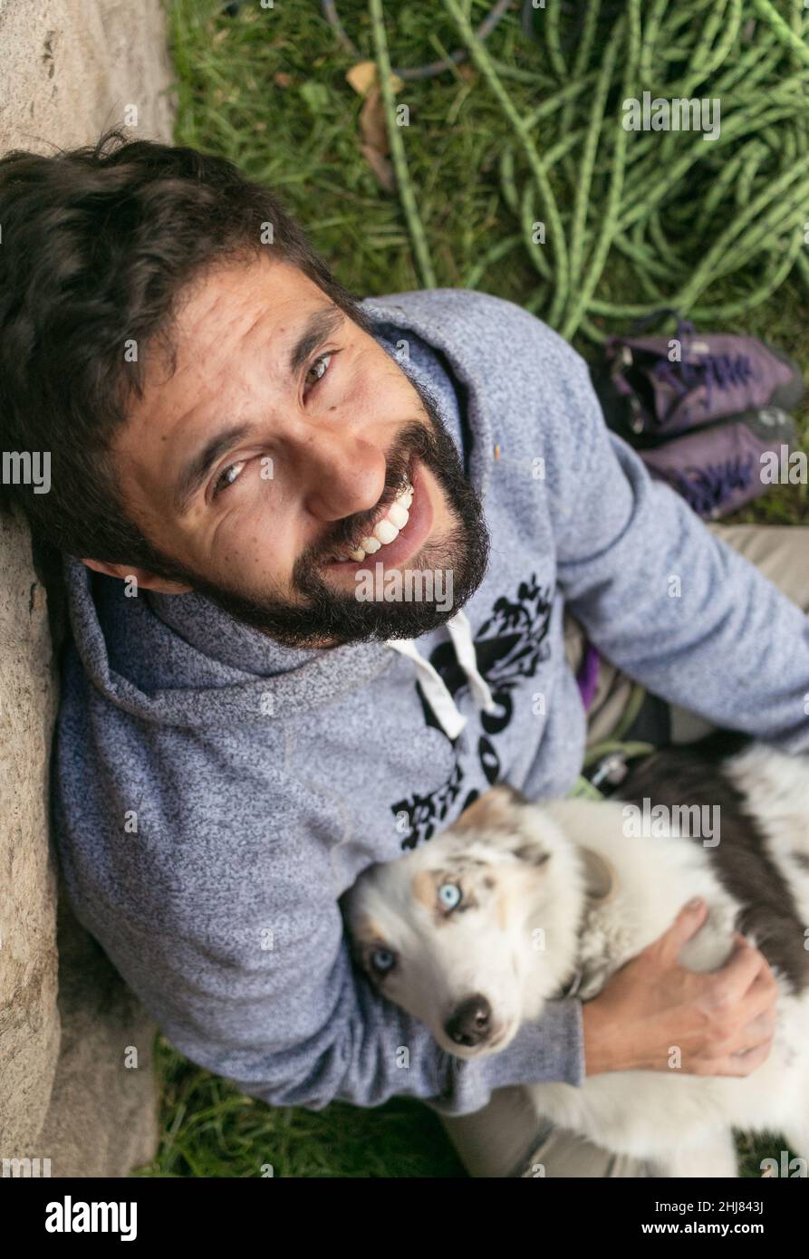 Hispanic man and brown border collie love each other outdoors Stock ...