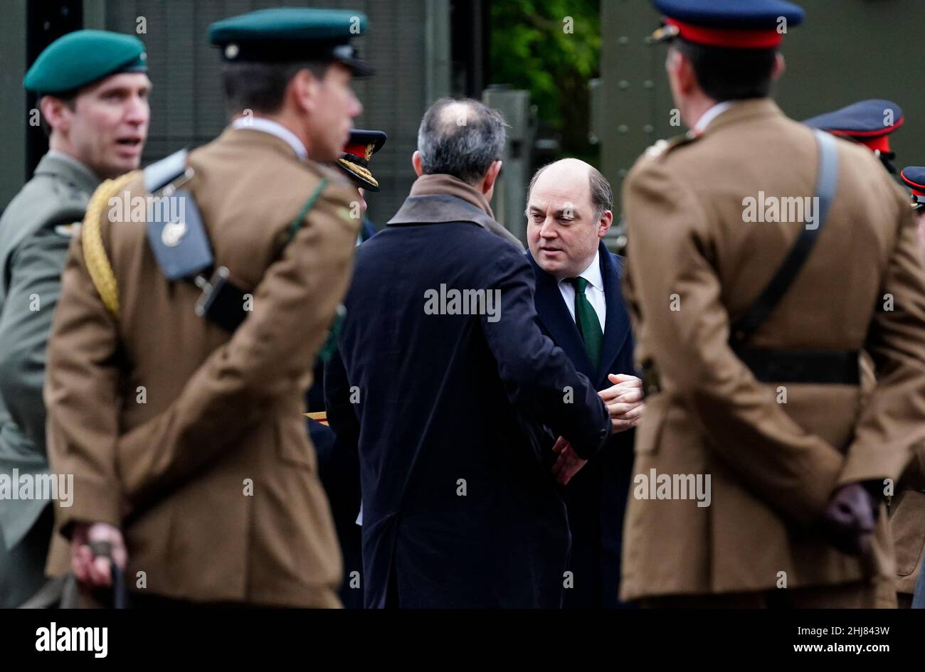 Defence Secretary Ben Wallace (2nd right) after the change of colours ...