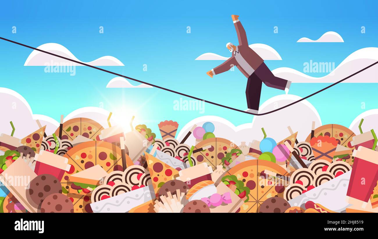 senior man balancing on rope above junk food assortment of fast food ...
