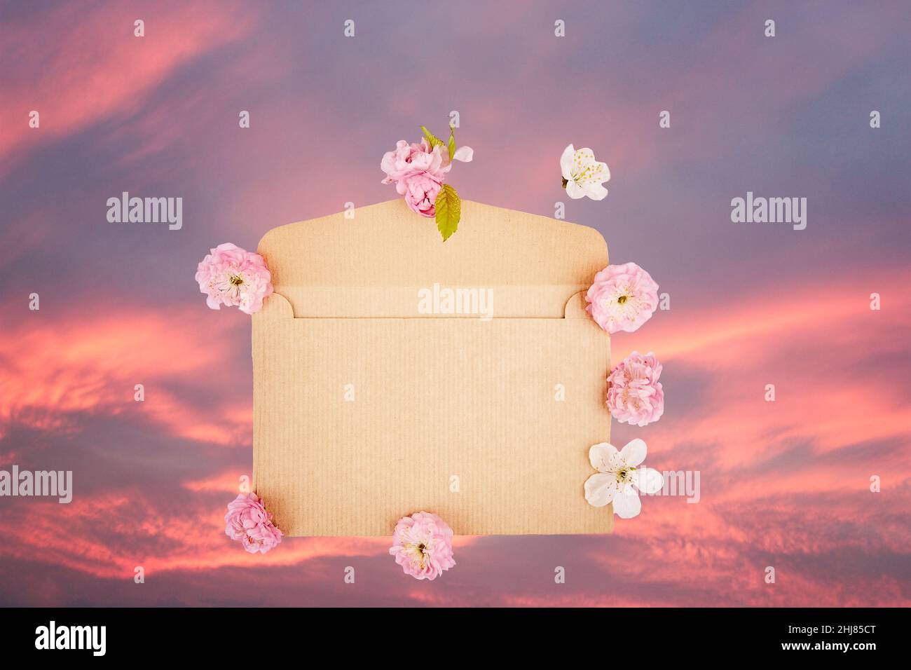 Bright spring envelope mock up with pink flowers on sunset sky vivid ...