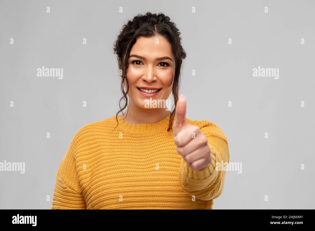 happy smiling young woman showing thumbs up Stock Photo - Alamy