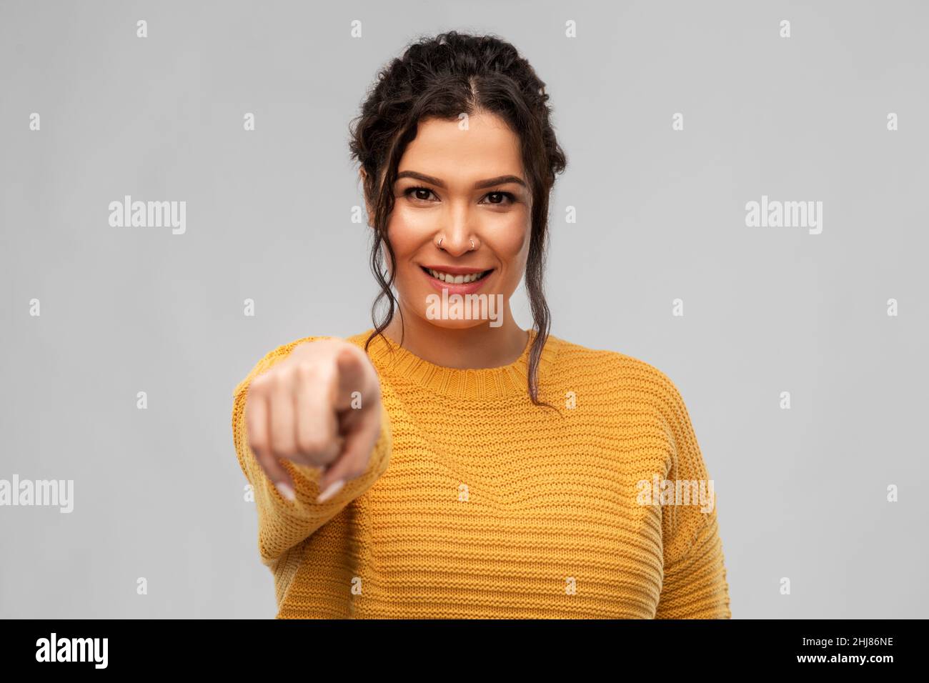 smiling young woman pointing finger to camera Stock Photo - Alamy