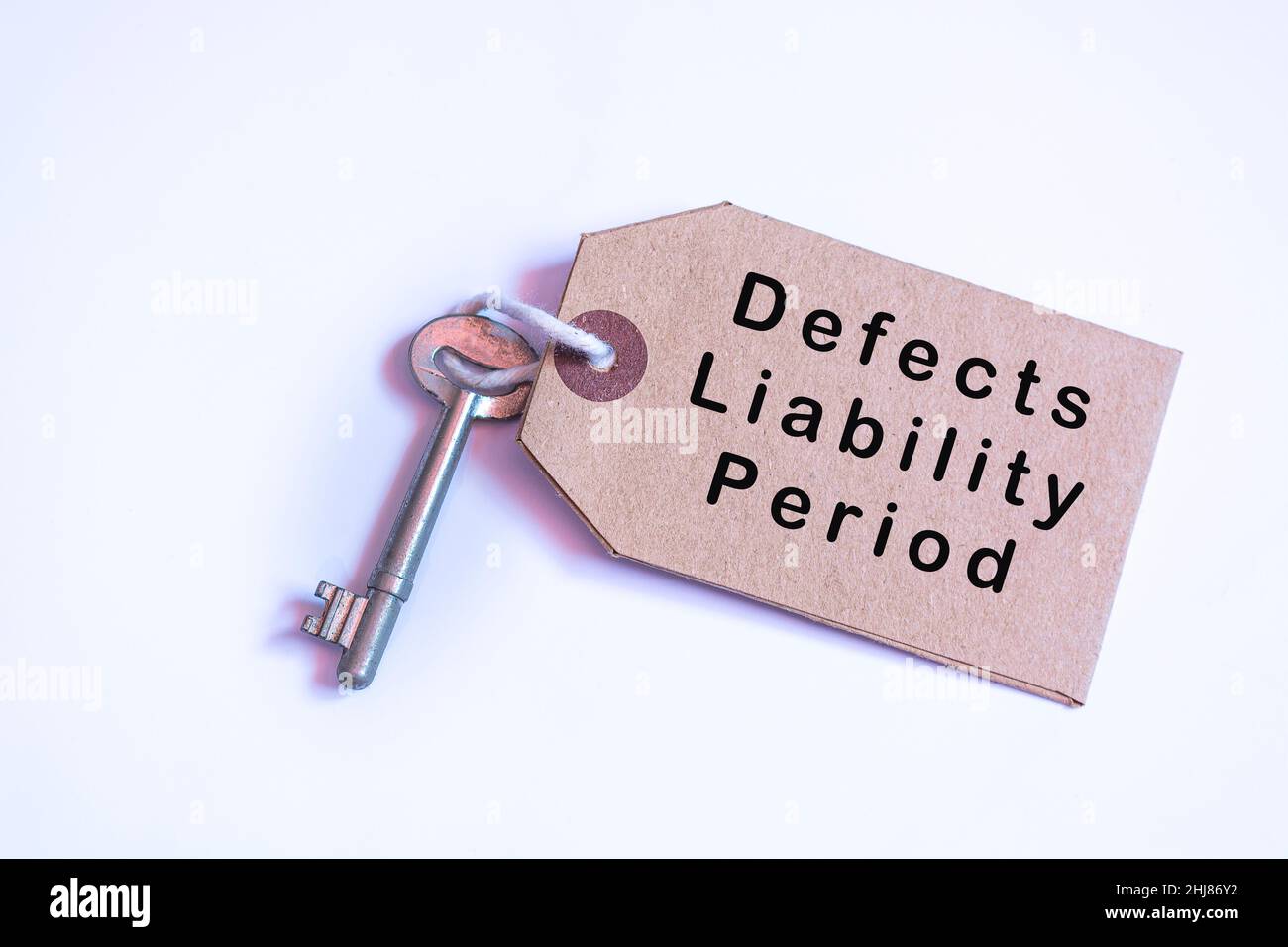Text on a tag with key on white background - Defects liability period ...
