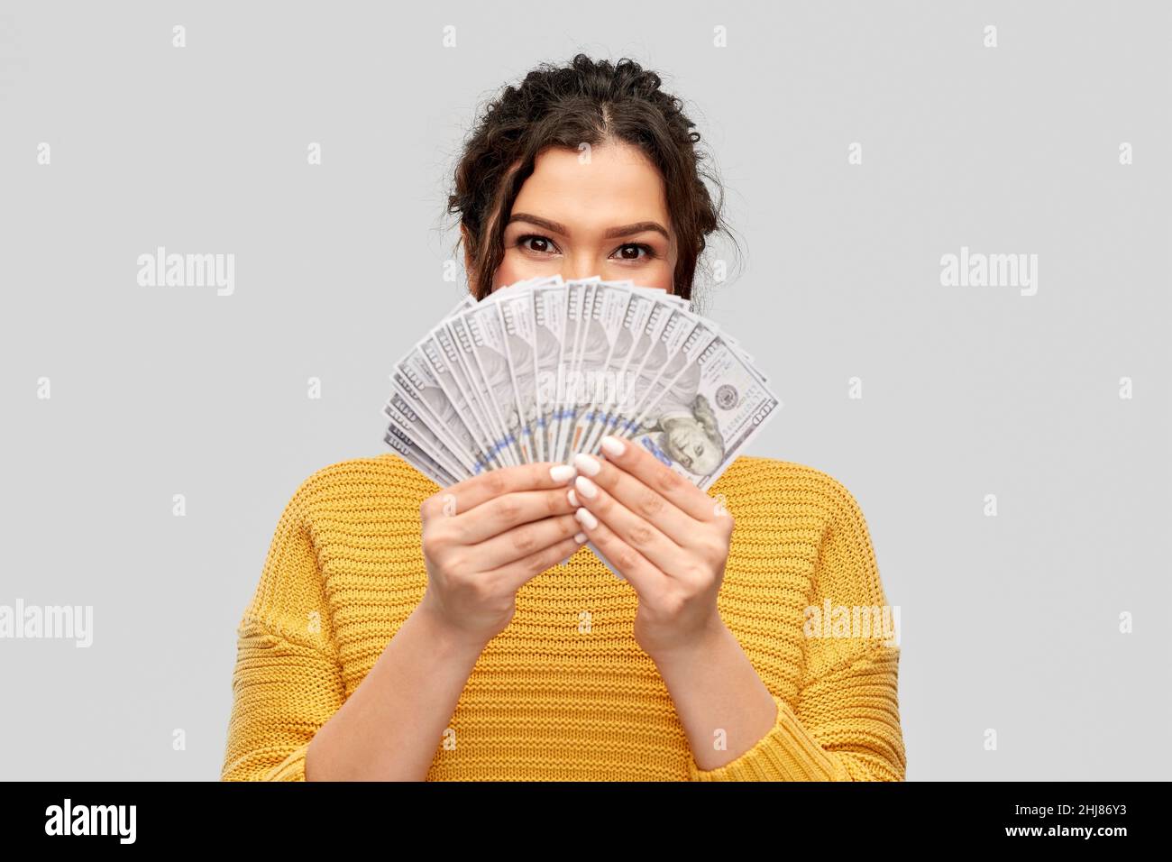 young woman covering her face with dollar money Stock Photo - Alamy
