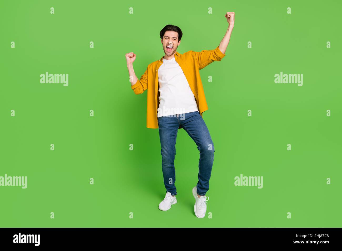 Full size photo of young handsome cheerful screaming guy raise fists ...