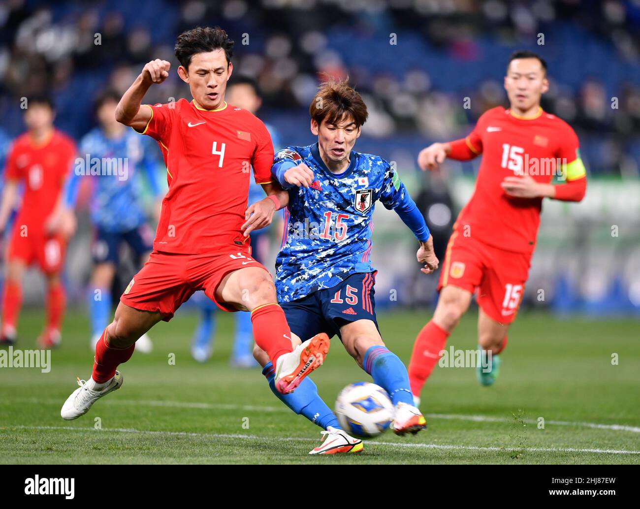 Saitama, Japan. 27th Jan, 2022. Osako Yuya (front, R) of Japan shoots during the Group B match ...