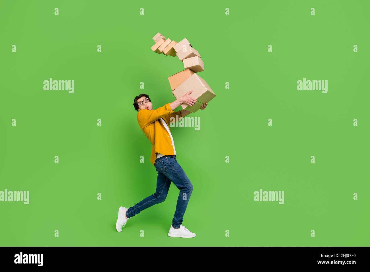 Full size photo of young amazed shocked guy hold carton boxes falling ...