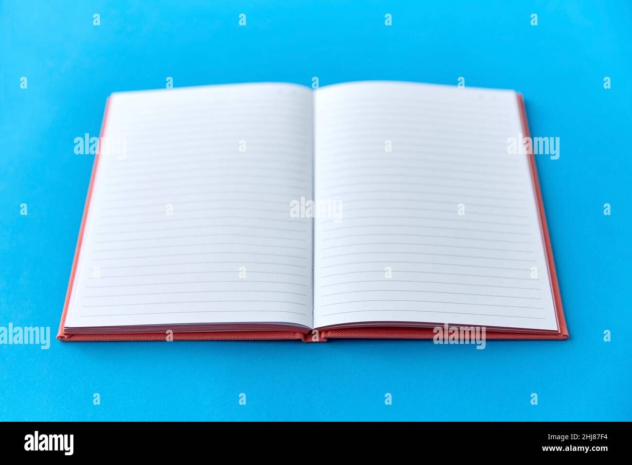 open notebook or diary on blue background Stock Photo - Alamy