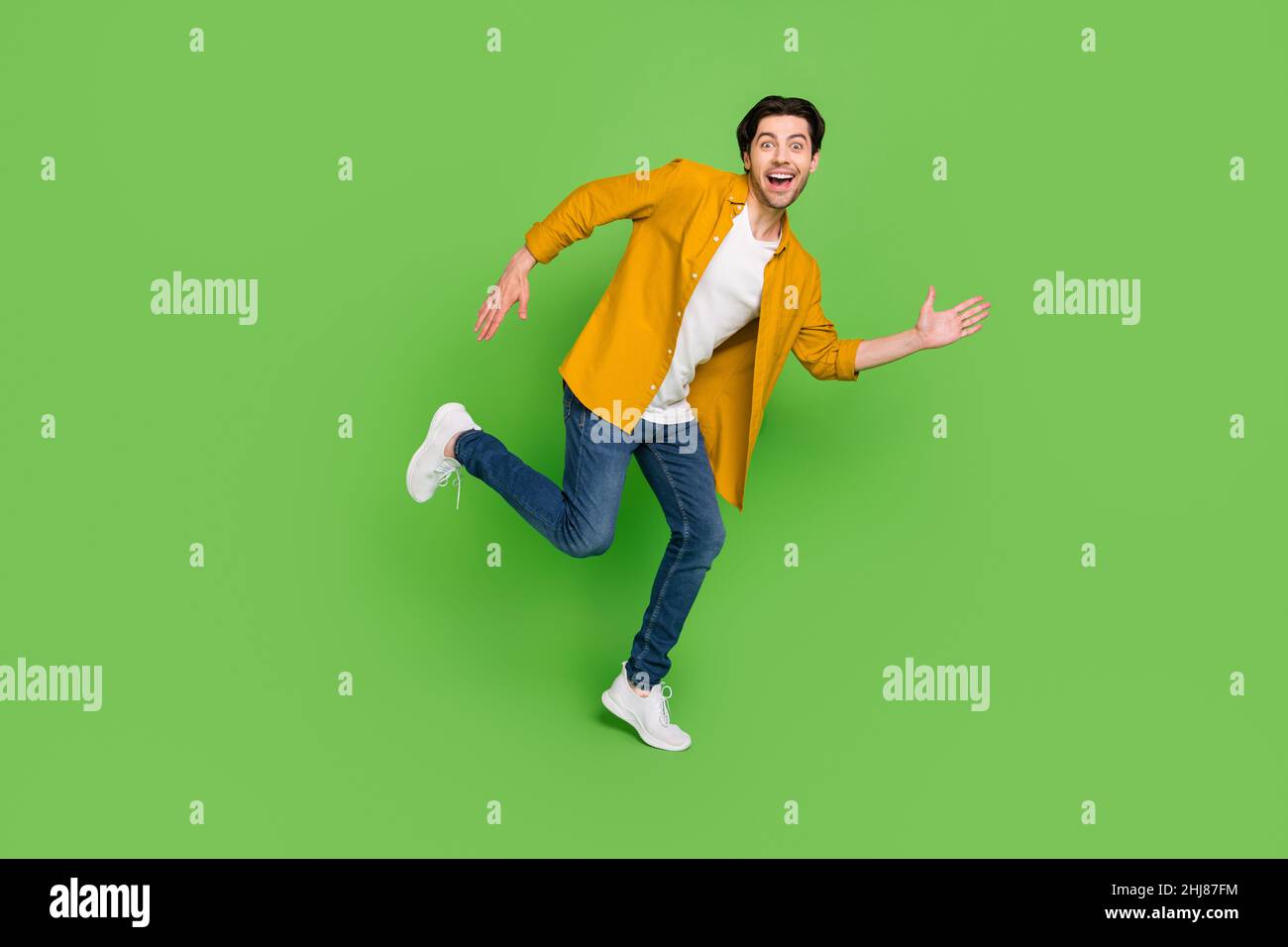 Full size profile side photo of young laughing cheerful man running ...