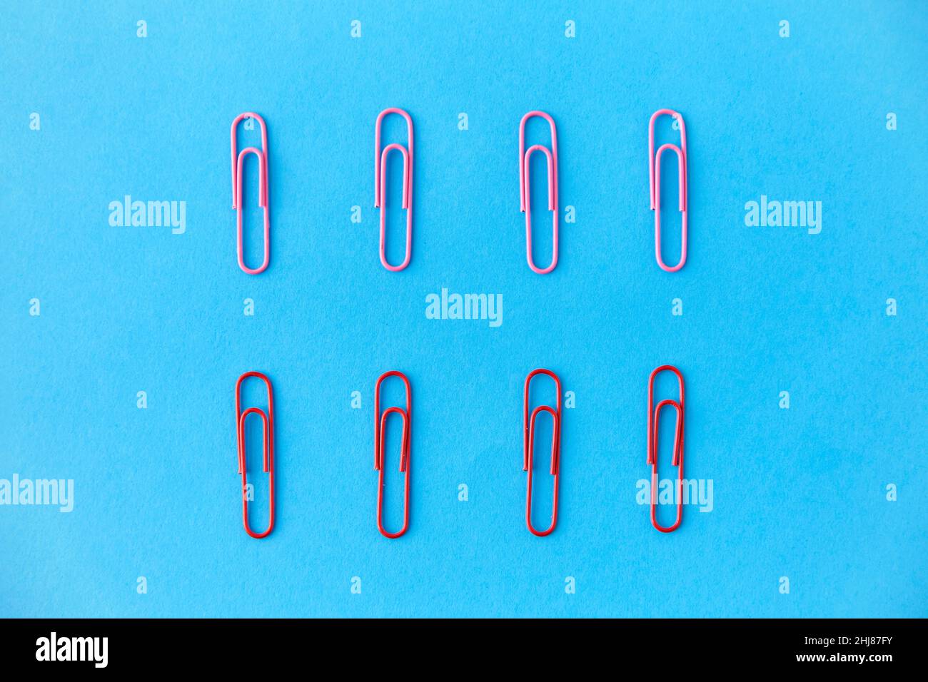 office clips on blue background Stock Photo - Alamy