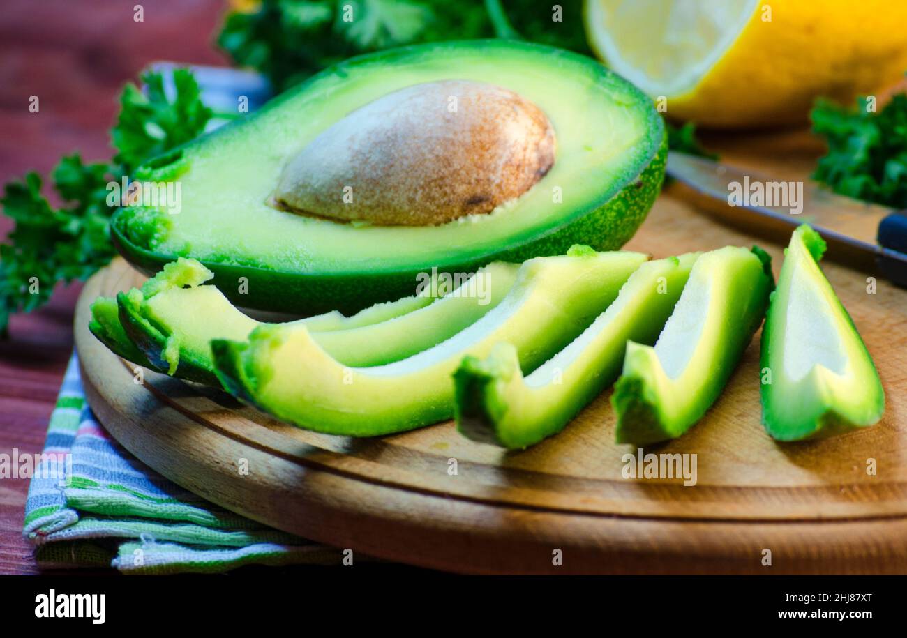 slices of fresh avocado on a cutting board Stock Photo - Alamy
