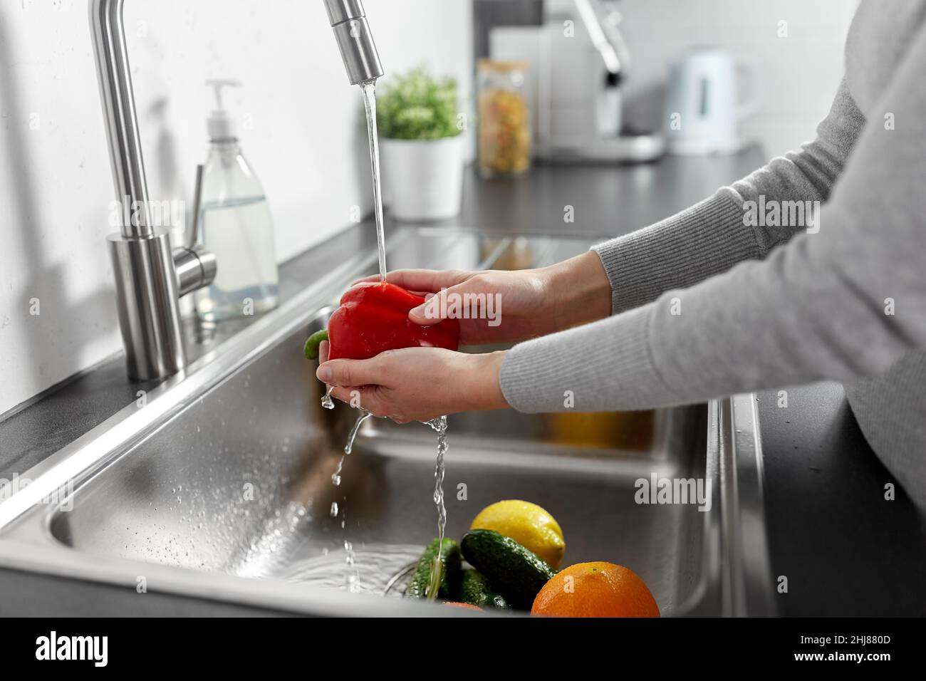 woman washing fruits and vegetables in kitchen Stock Photo - Alamy