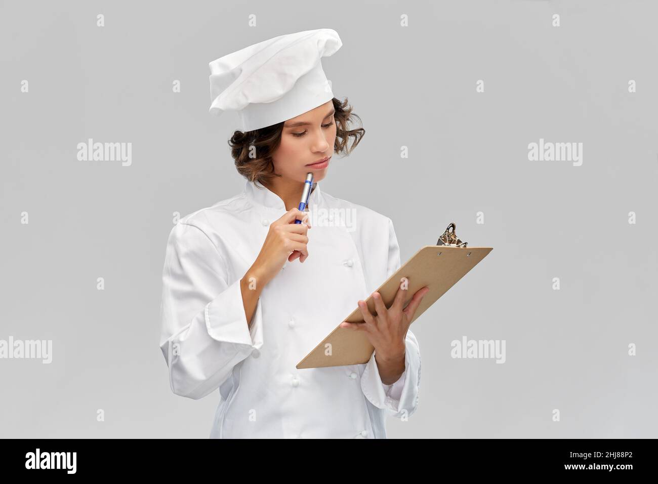 female chef in toque with clipboard Stock Photo - Alamy