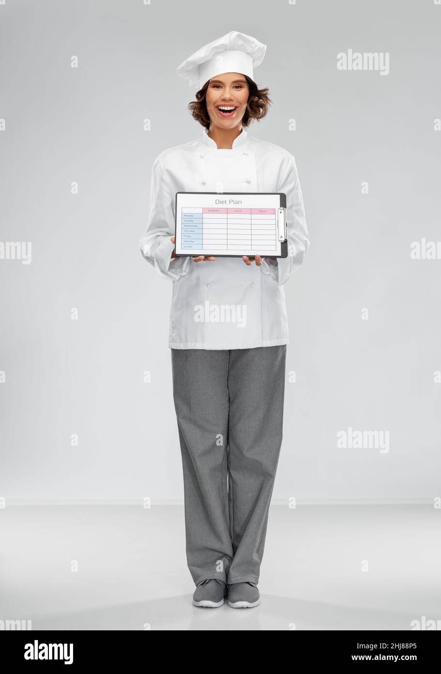 smiling female chef holding with diet plan Stock Photo - Alamy