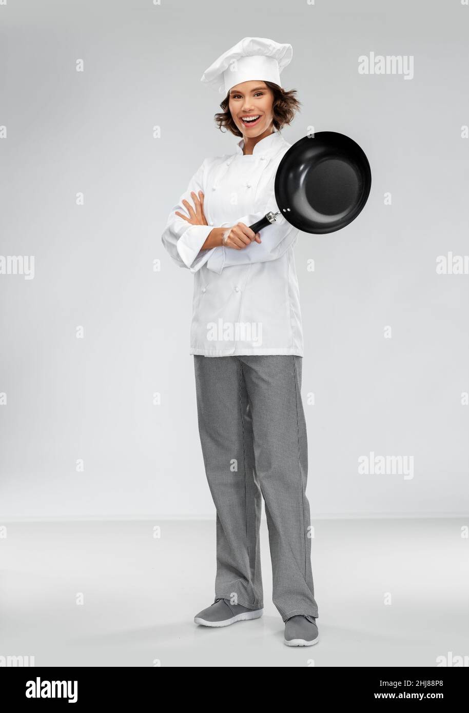 smiling female chef in toque with frying pan Stock Photo - Alamy