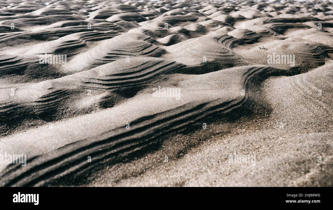 Unusual shapes made in the sand from the retreating sea Stock Photo - Alamy