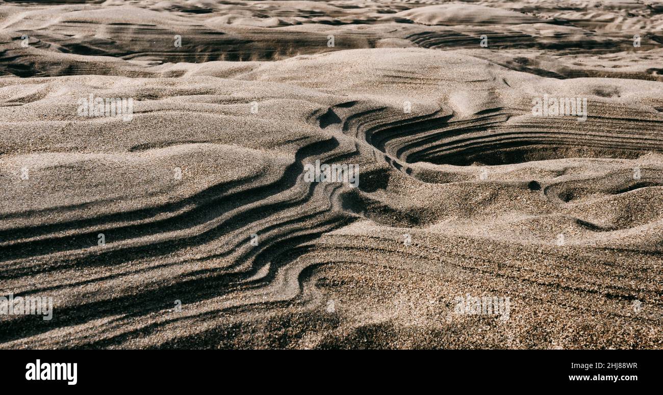 Unusual shapes made in the sand from the retreating sea Stock Photo - Alamy