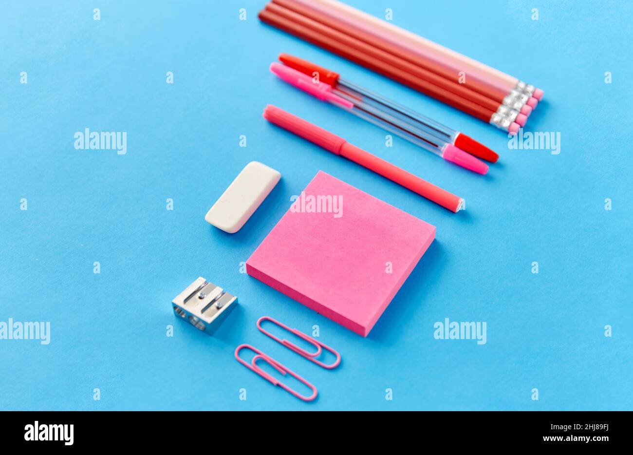 pink sticky notes, pens, pencils, clips and eraser Stock Photo - Alamy